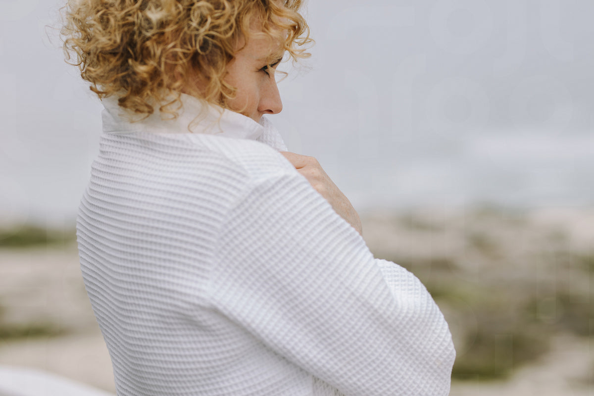 Close up of a woman in white coat looking at the sea – Jacob Lund ...