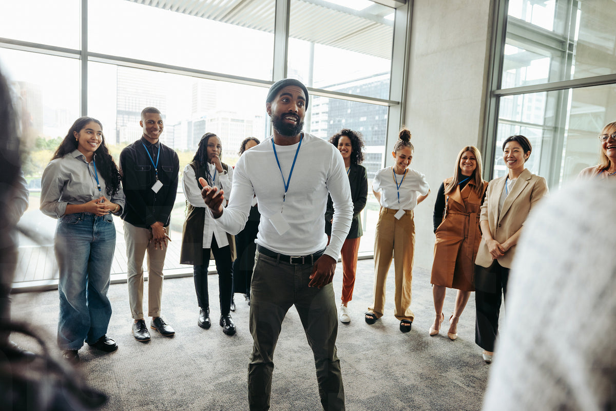 Confident businessman leading an engaging team-building session in a m ...