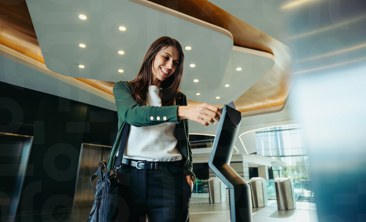 Smiling businesswoman swiping keycard at entrance checkpoint – Jacob ...