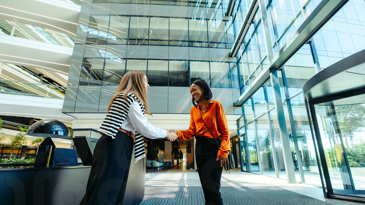 Professional greeting between colleagues in modern office lobby – Jacob ...
