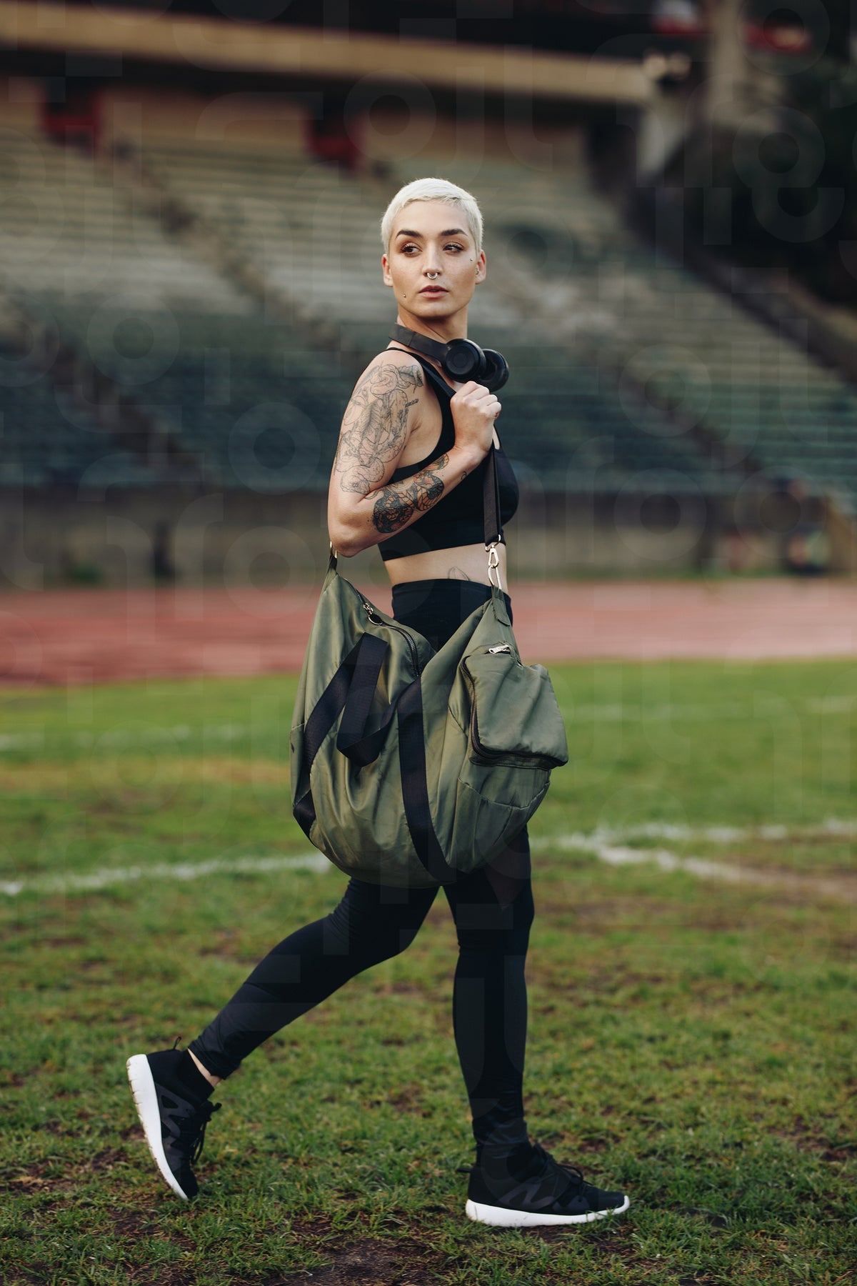 Fitness woman walking inside a track and field ground – Jacob Lund ...