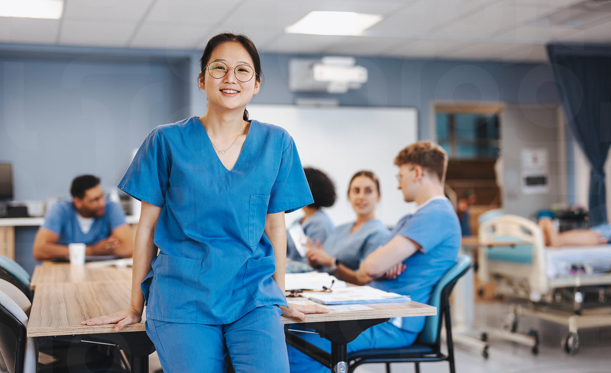 Young Asian student wearing medical scrubs in a teaching hospital ...