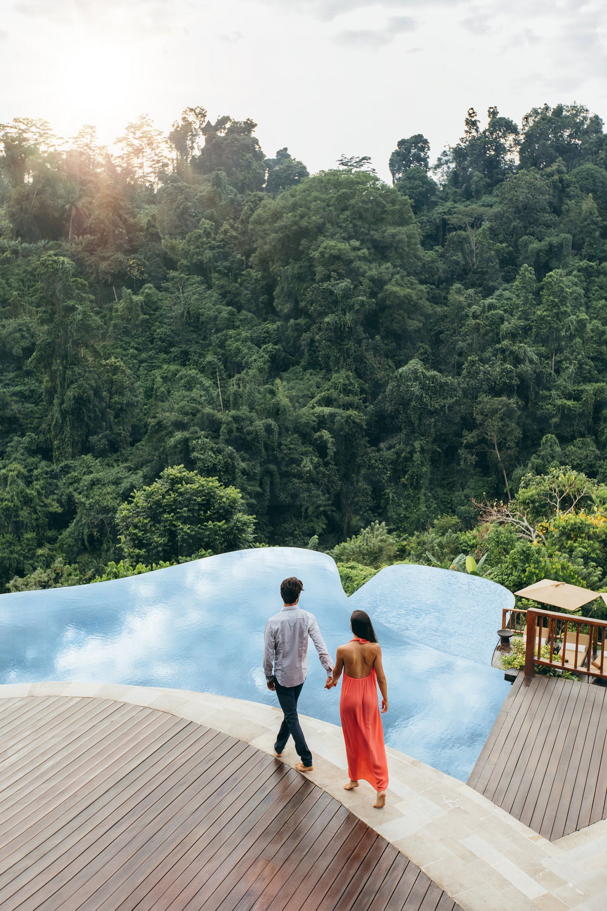 Young couple walking towards pool at luxury resort – Jacob Lund ...