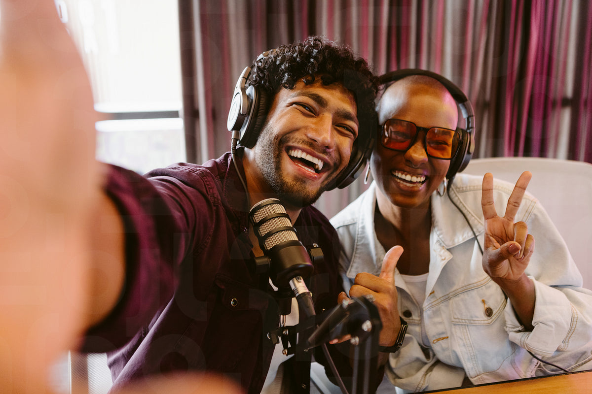 Happy podcast hosts recording a show together in a studio – Jacob Lund ...