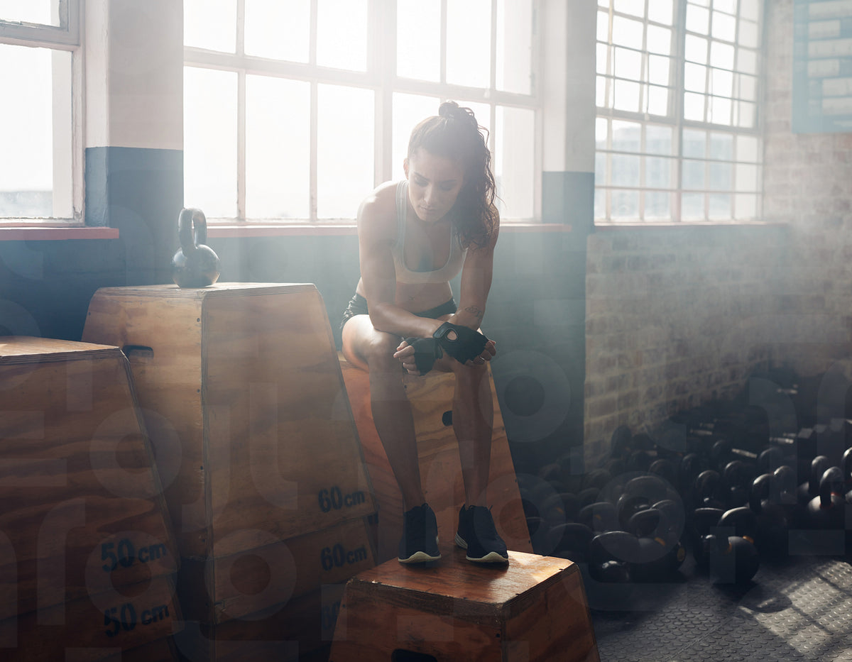 Female athlete taking break after exercising at gym – Jacob Lund ...