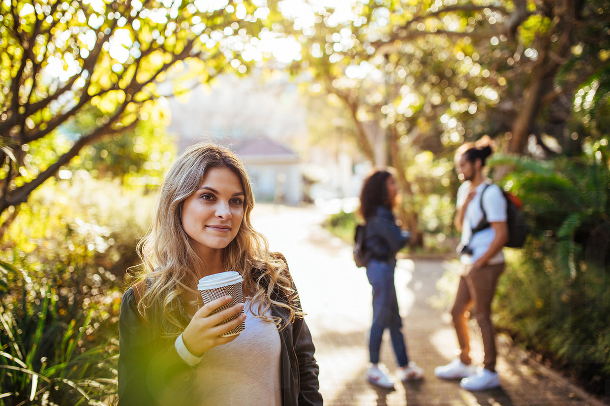Woman in park holding a coffee glass – Jacob Lund Photography Store ...