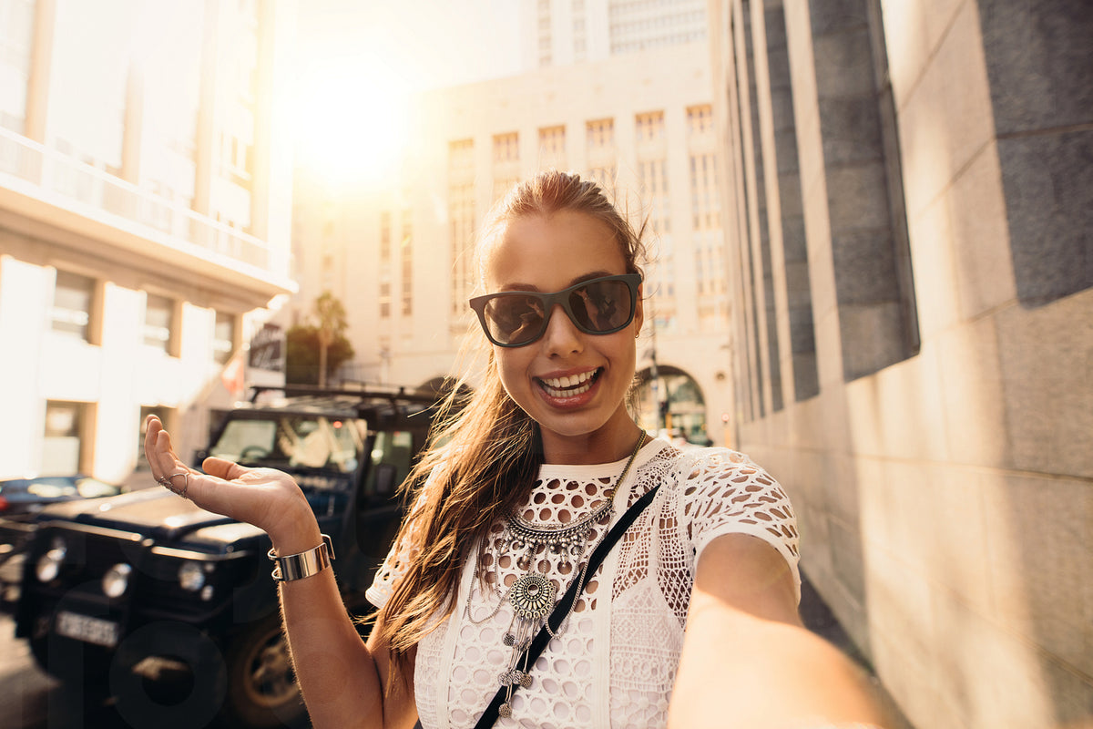 Tourist taking selfie in a street surrounded by buildings. – Jacob Lund ...