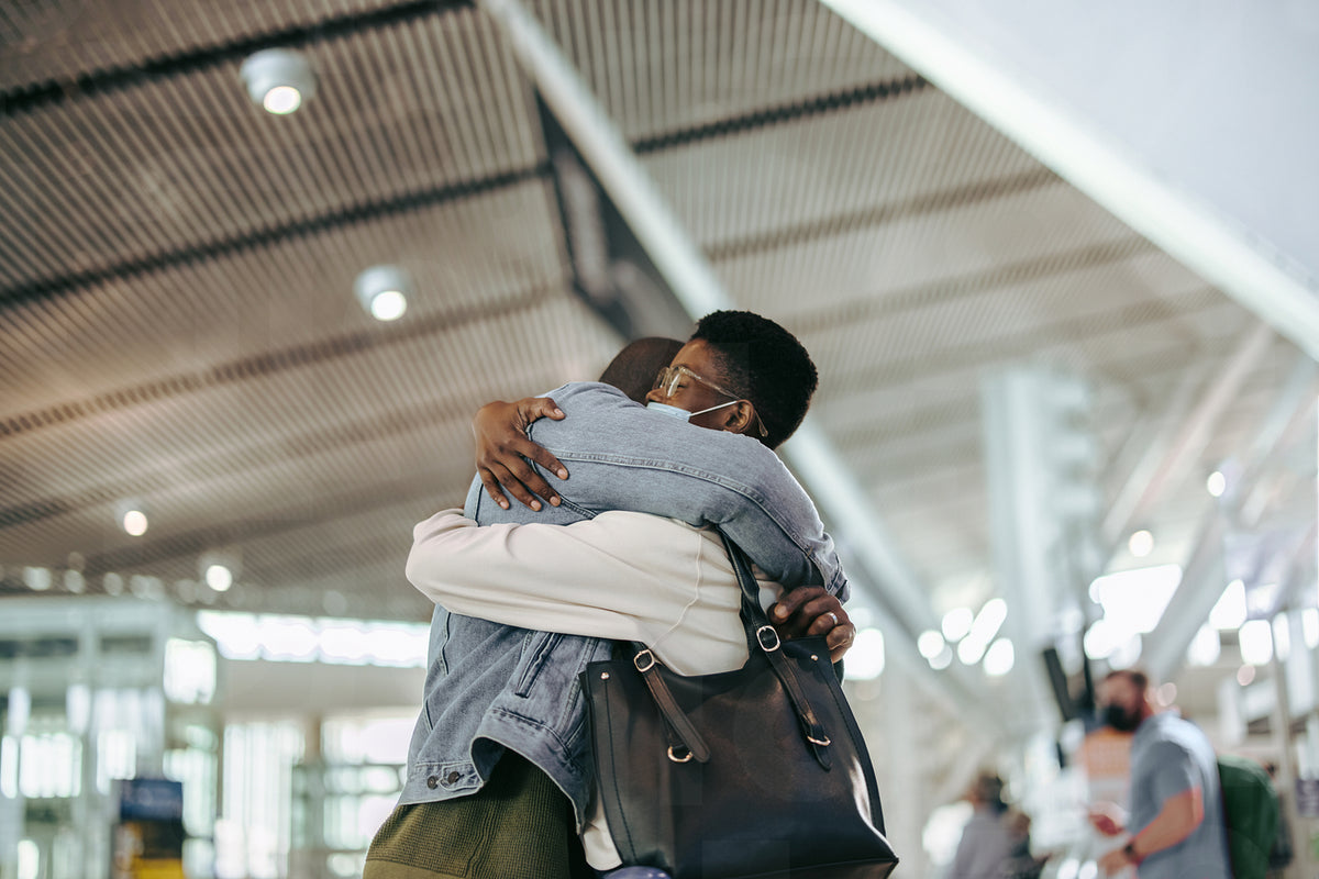 Man and woman giving good bye hug at airport – Jacob Lund Photography ...
