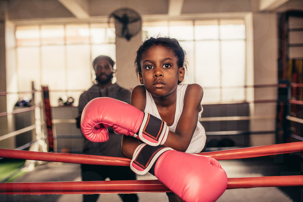 Girl wearing boxing gloves standing near a boxing ring – Jacob Lund ...