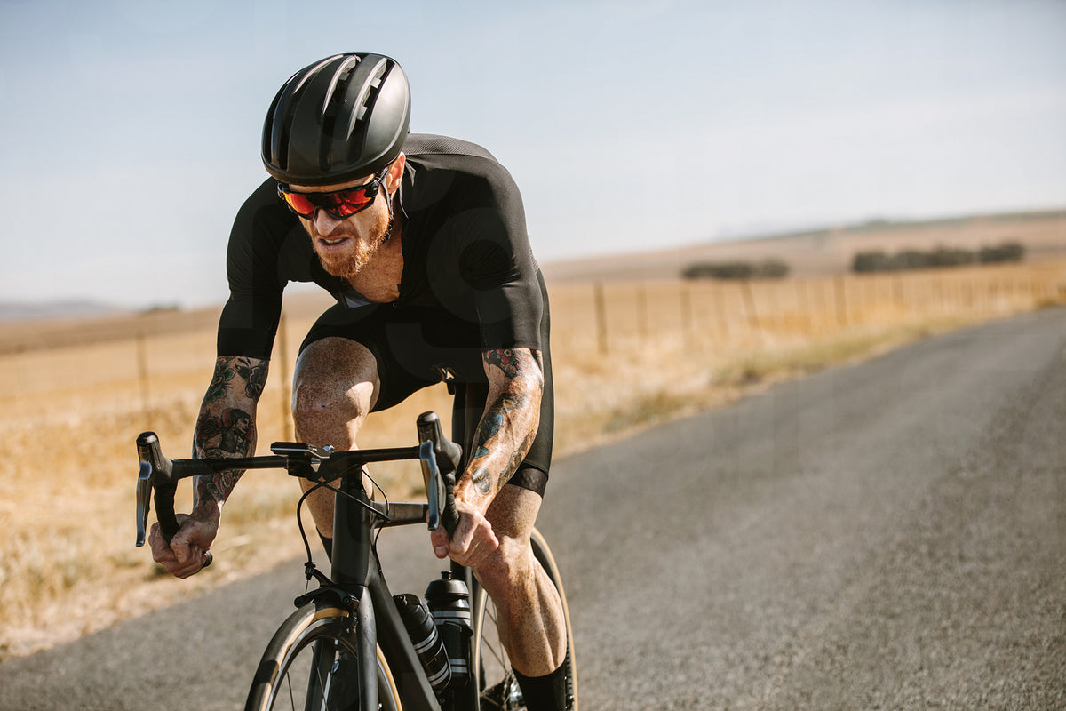 Cyclist on road bike through countryside road – Jacob Lund Photography ...