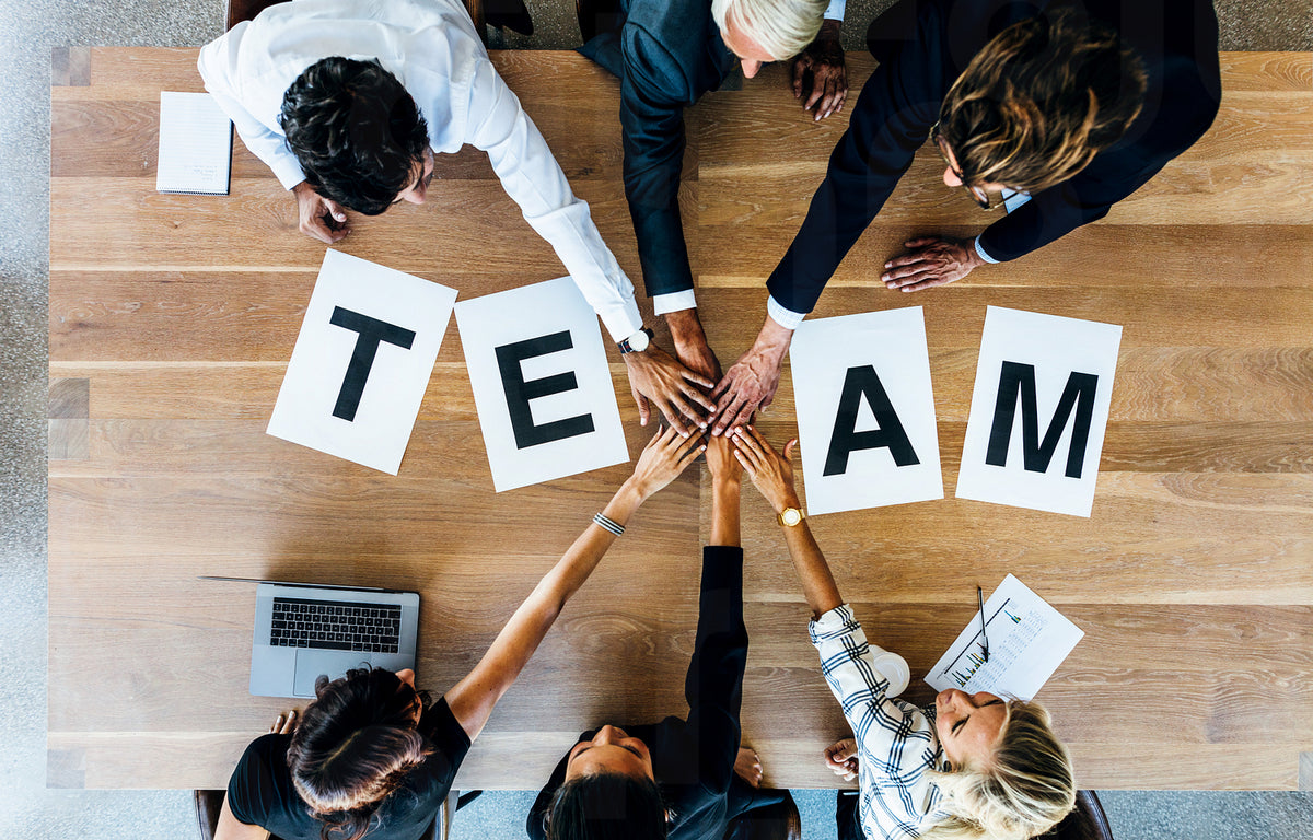 Team word on table with business people stacking hands – Jacob Lund ...