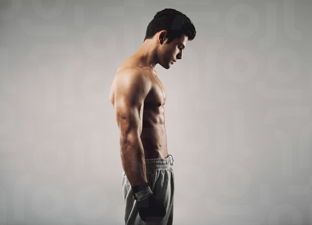 Fit young man wearing boxing gloves looking down – Jacob Lund ...