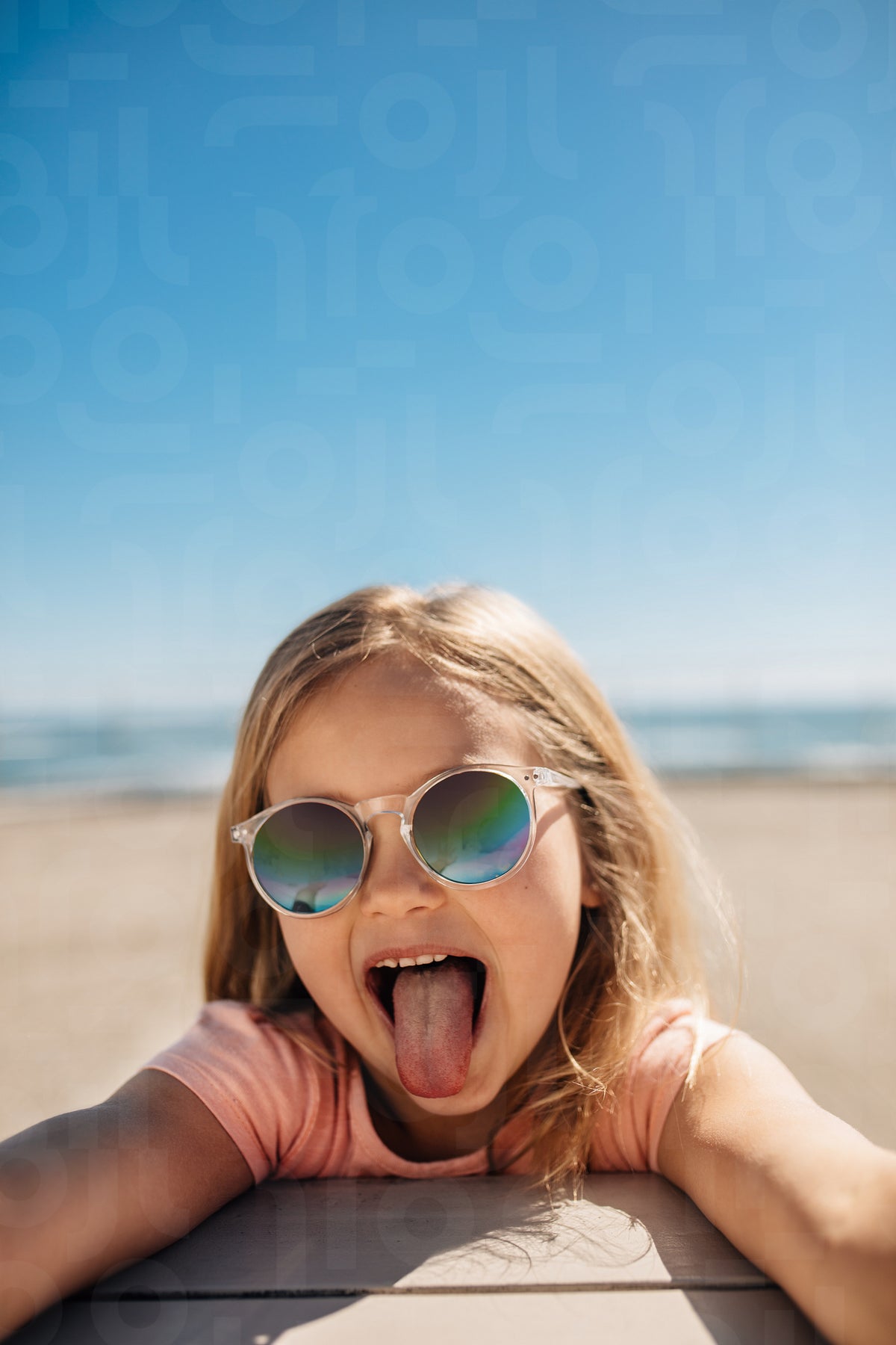 Playful girl at the beach sticking out her tongue – Jacob Lund ...