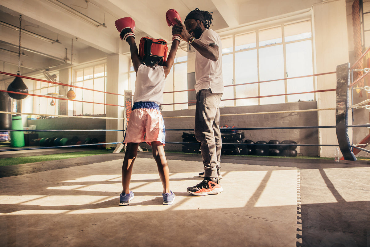 Coach raising the hand of a boxing kid in appreciation – Jacob Lund ...