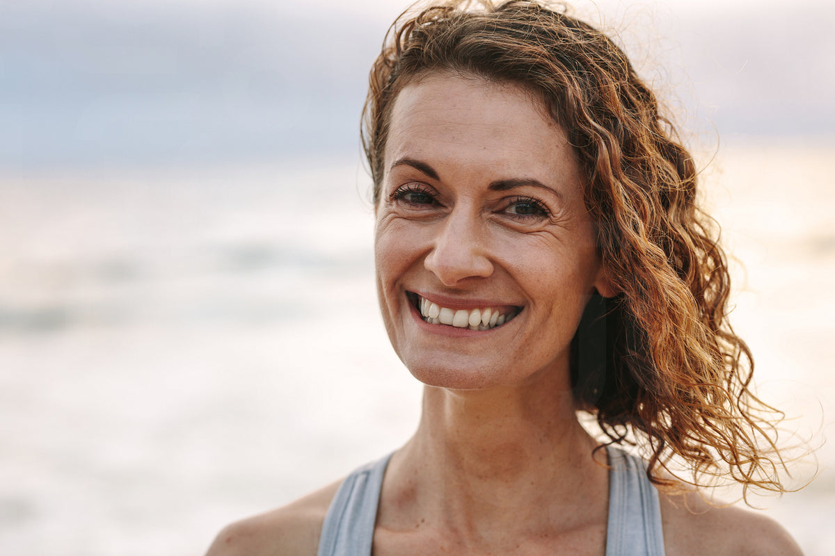 Portrait of a fitness woman standing at the beach – Jacob Lund ...