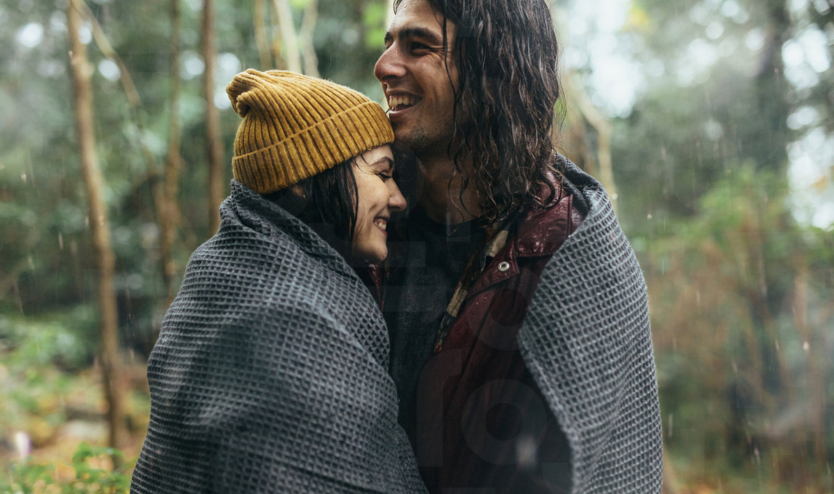 Couple in love standing under the rain wrapped in a blanket – Jacob ...