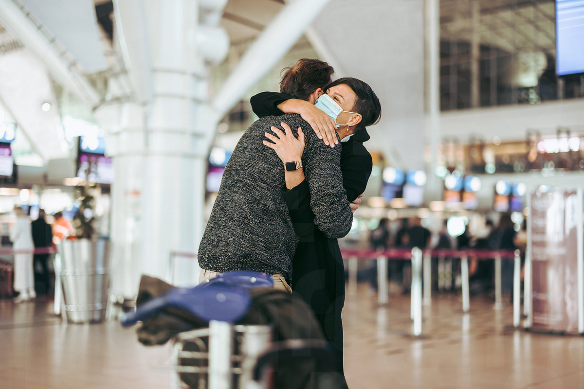 Woman embracing man at airport after long separation – Jacob Lund ...