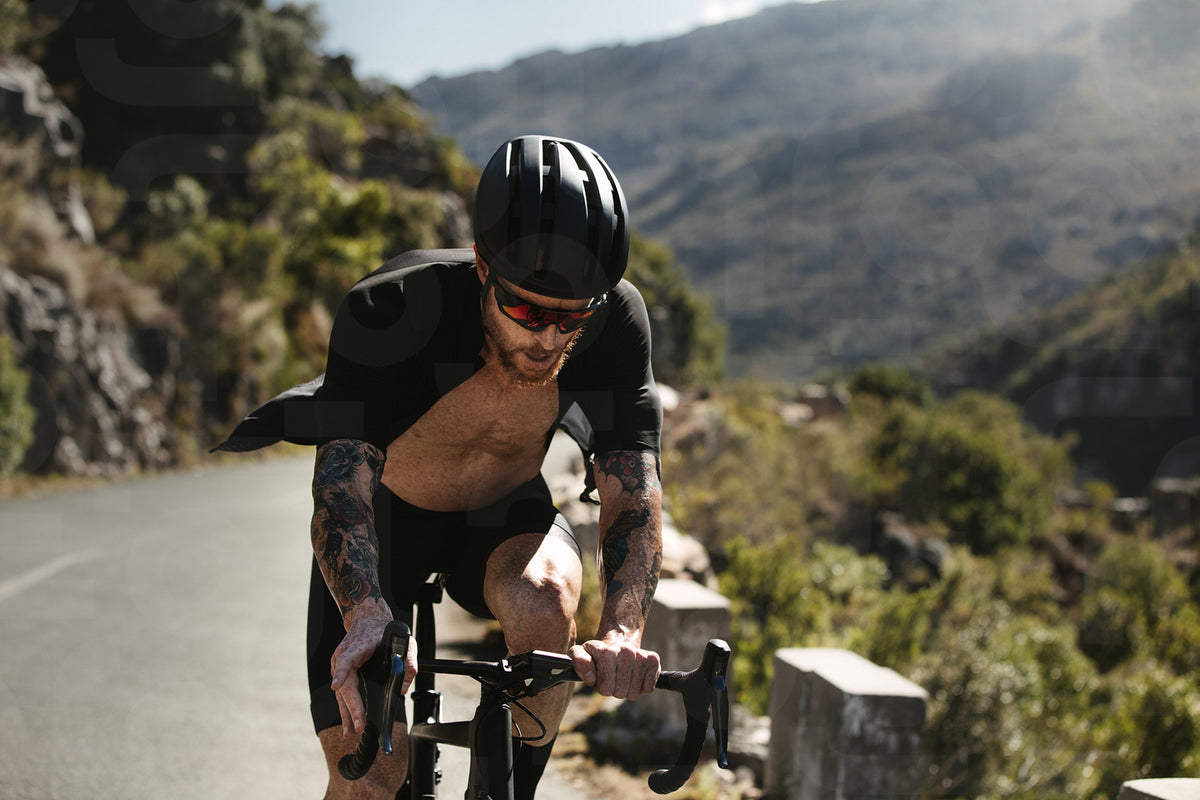 Fit cyclist doing uphill bicycle ride – Jacob Lund Photography Store ...