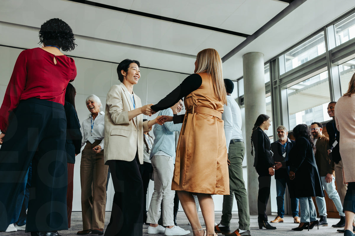 Women greeting and mingling at an office event with colleagues – Jacob ...