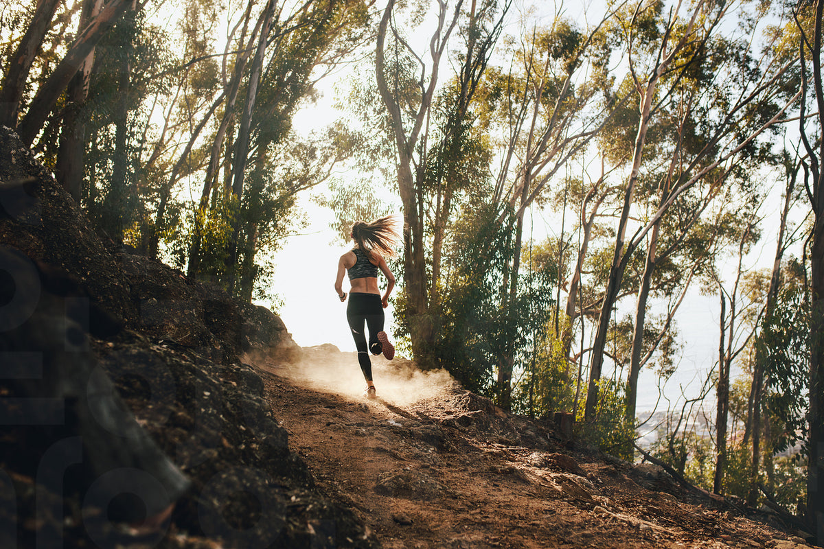 Woman trail running on a mountain path – Jacob Lund Photography Store ...