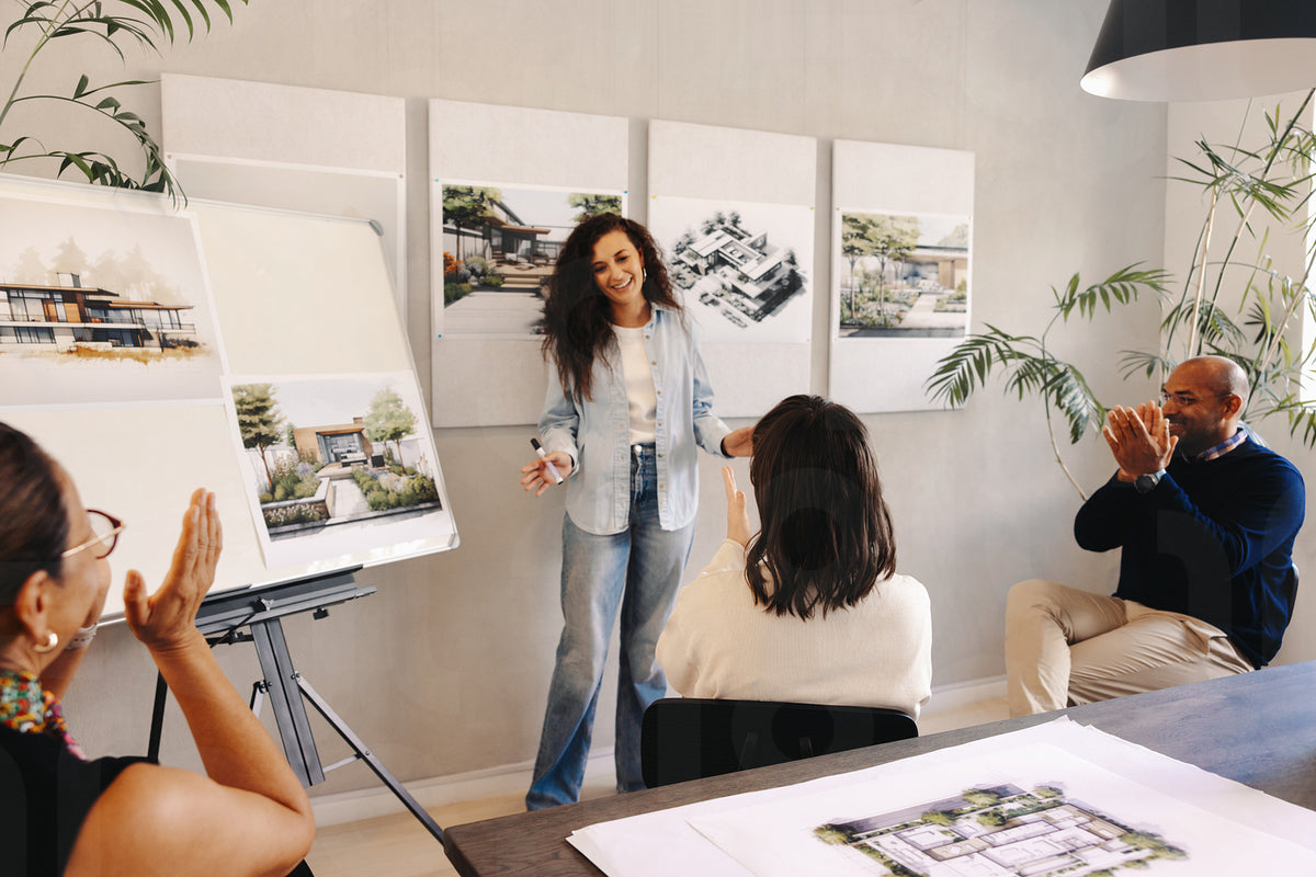 Young female architect presenting her design during a meeting with app ...