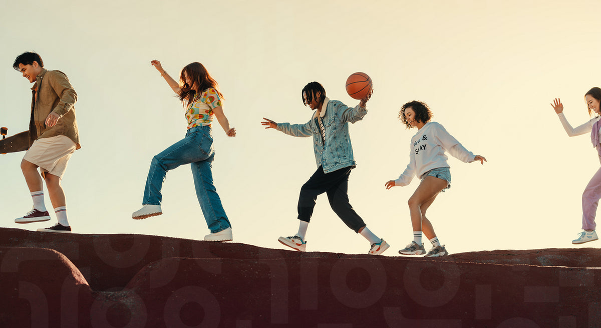 Young friends walking on a ledge together, enjoying good times outdoor ...