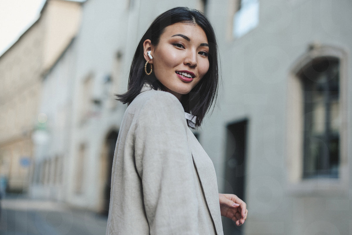 Woman with earphones walking in the city – Jacob Lund Photography Store ...