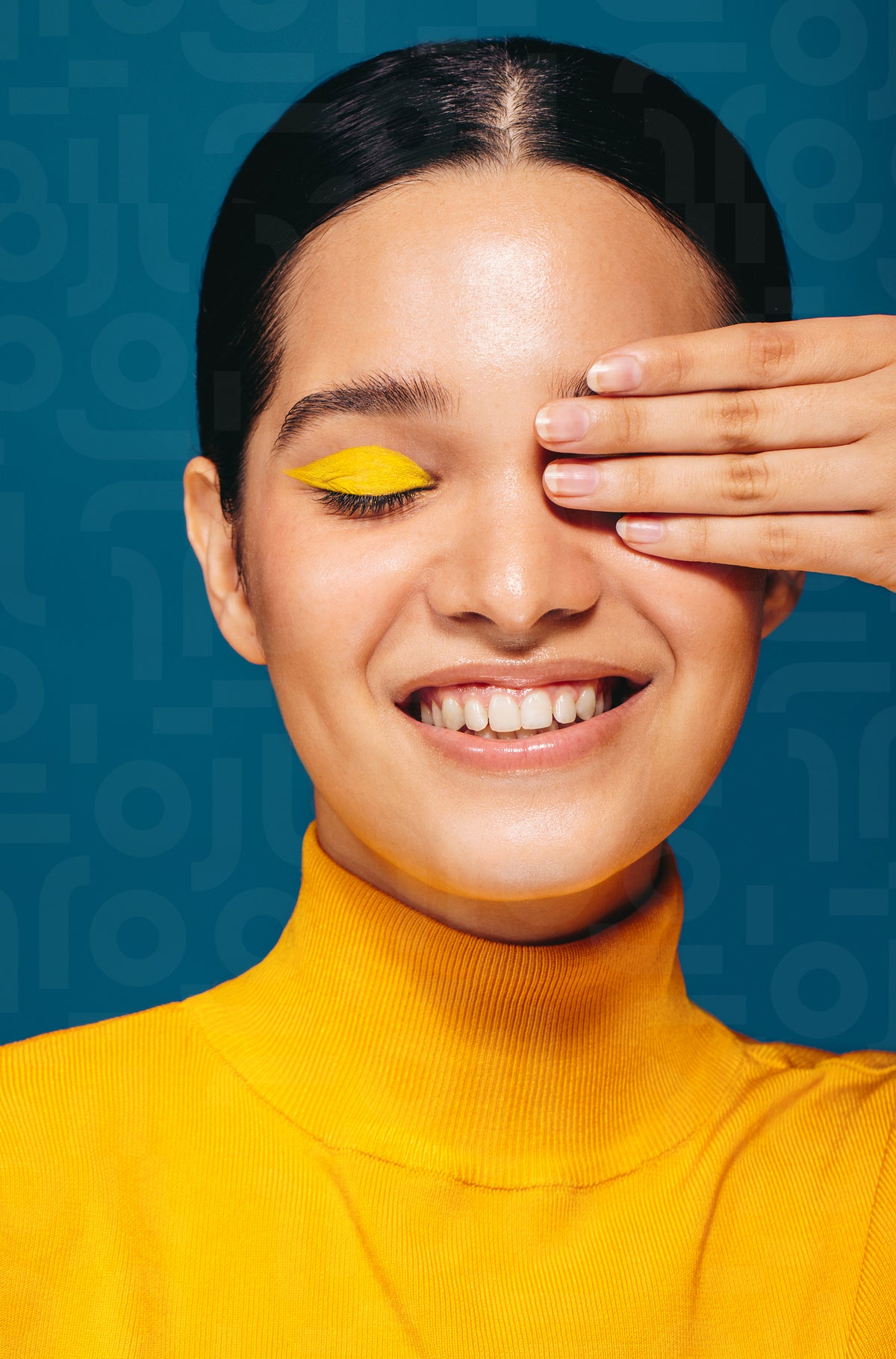Wearing vibrant eye shadow, woman covers her eye in a studio – Jacob ...