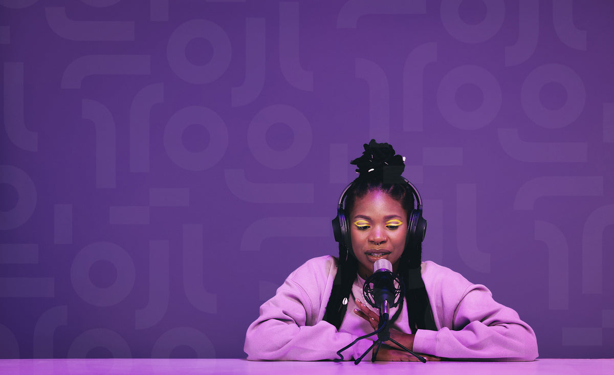 Female podcaster whispering into a microphone in a recording studio ...