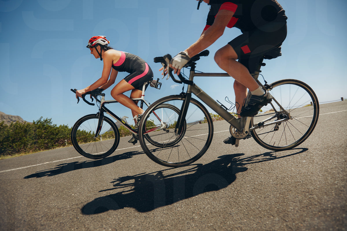 Cyclist riding bicycles down hill on country road – Jacob Lund ...