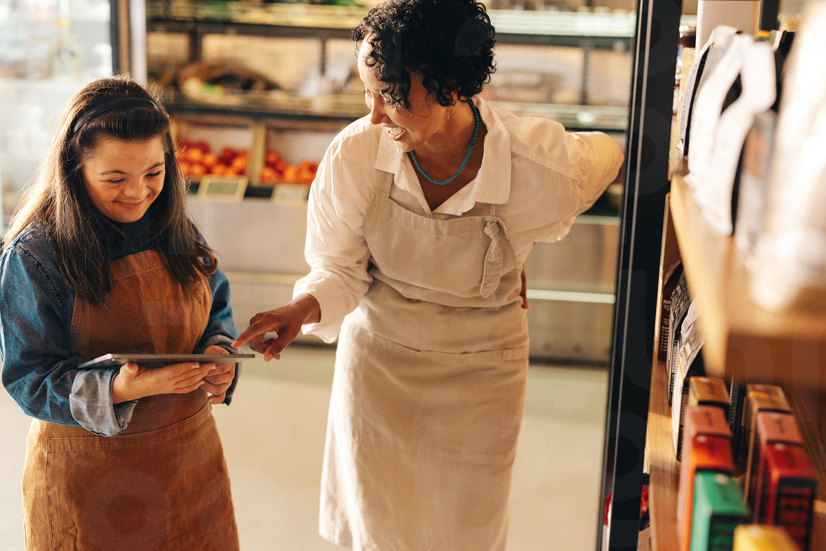 Cheerful grocery store owners using a digital tablet together – Jacob ...