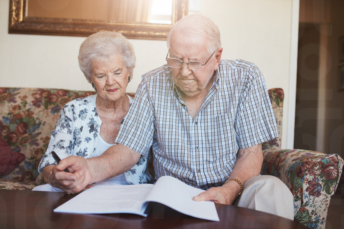 Retired couple looking over documents at home – Jacob Lund Photography ...
