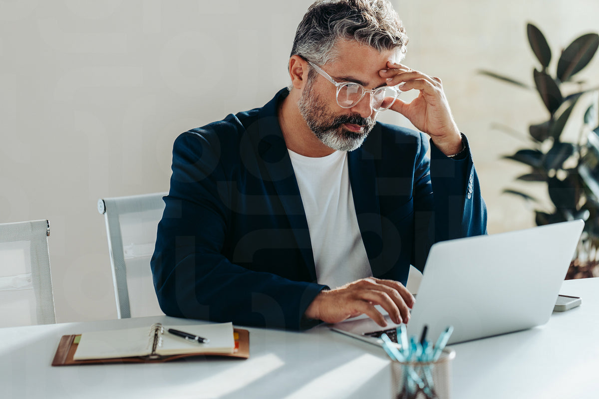 Stressed businessman facing work challenges at the office – Jacob Lund ...