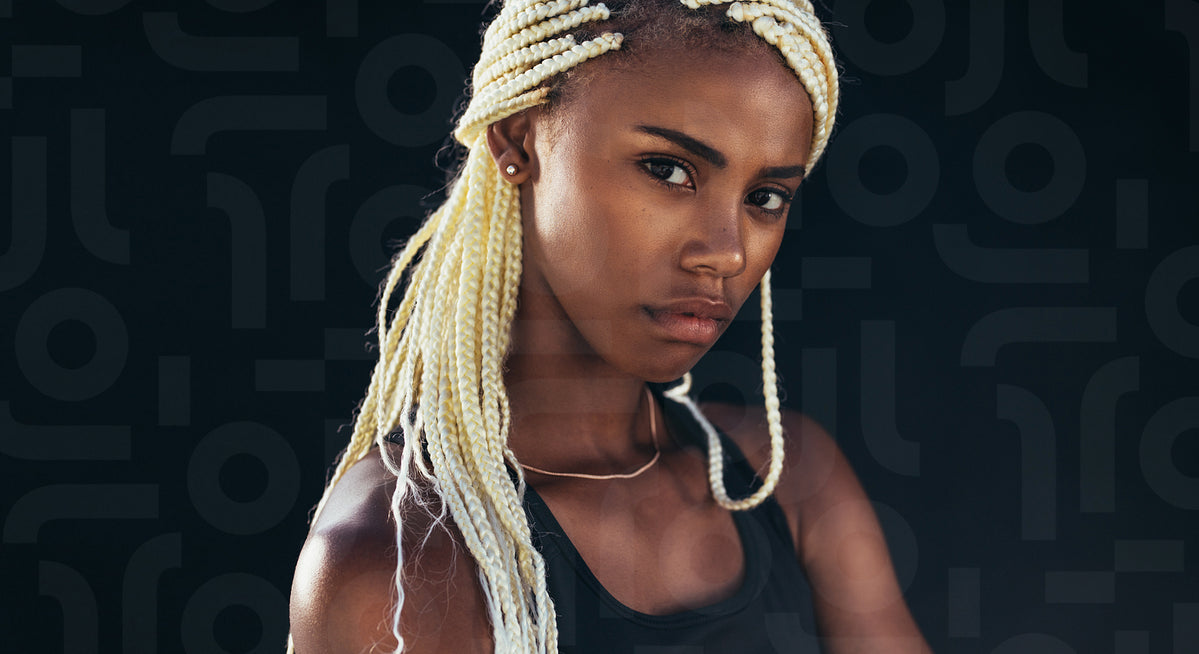 Close up portrait of a female athlete standing against black backgroun ...