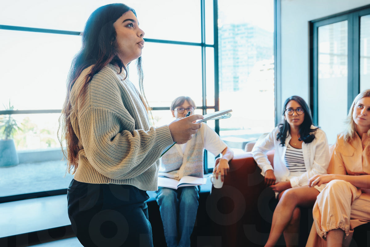 Confident student delivering a presentation in a class setting, showca ...