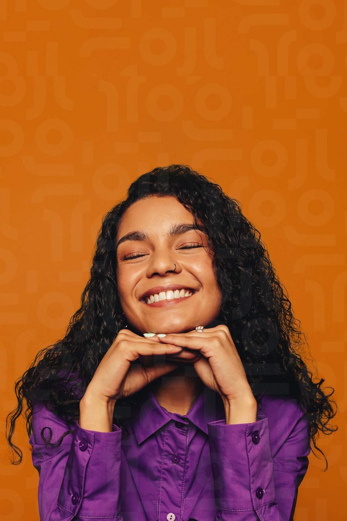 Vibrant smiling woman with curly hair on orange background – Jacob Lund ...
