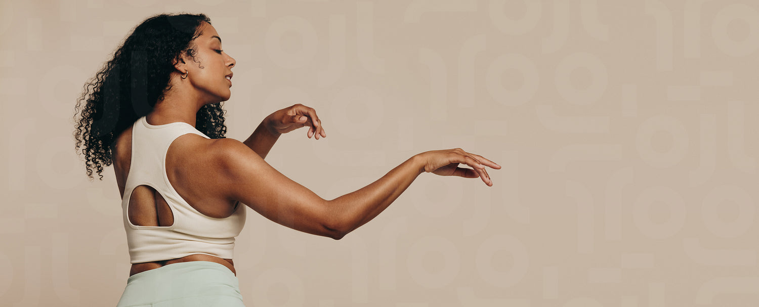 Sporty woman doing an expressive body movement in fitness clothing ...