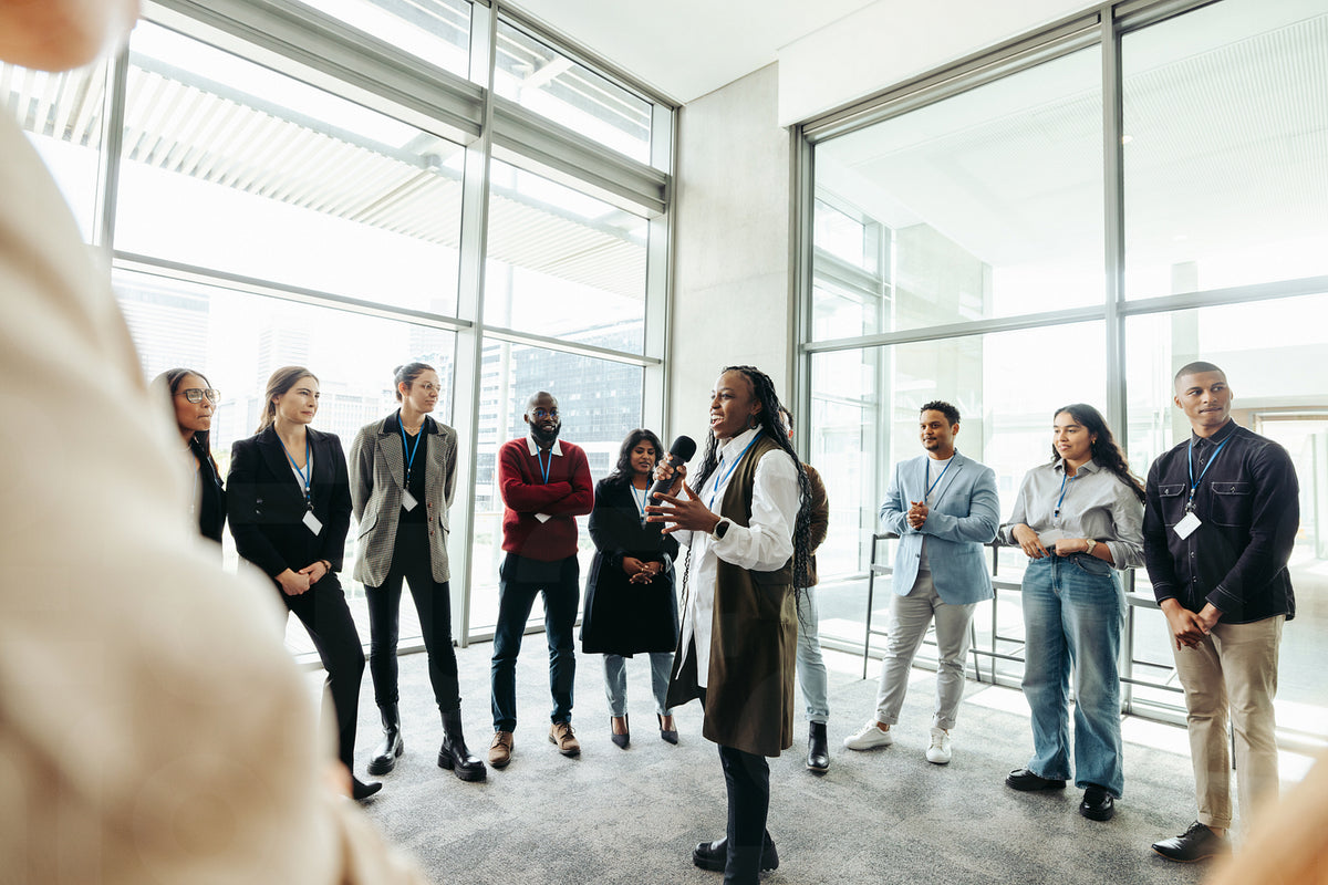 Leader addressing a crowd at a seminar in a modern office space – Jacob ...