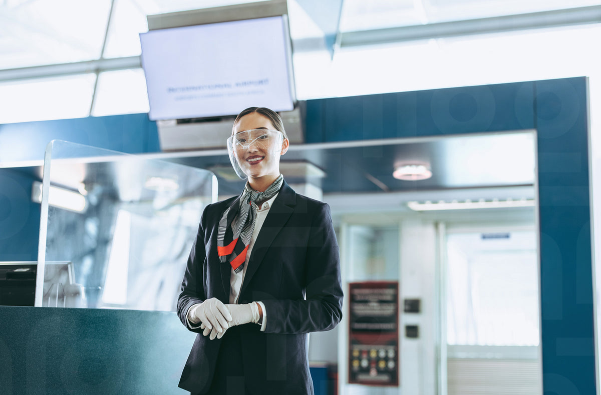 Airlines attendant with face shield standing at airport – Jacob Lund ...