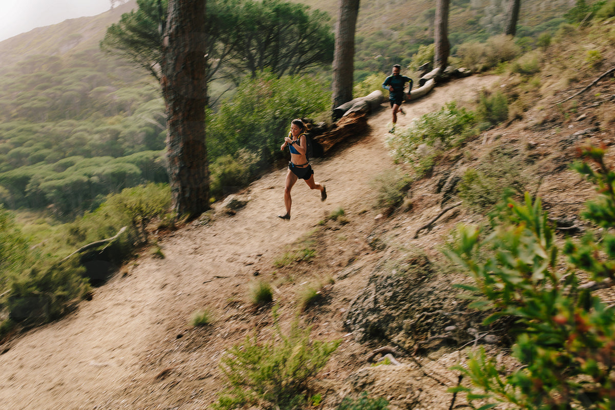 Young couple trail running on a mountain path. – Jacob Lund Photography ...