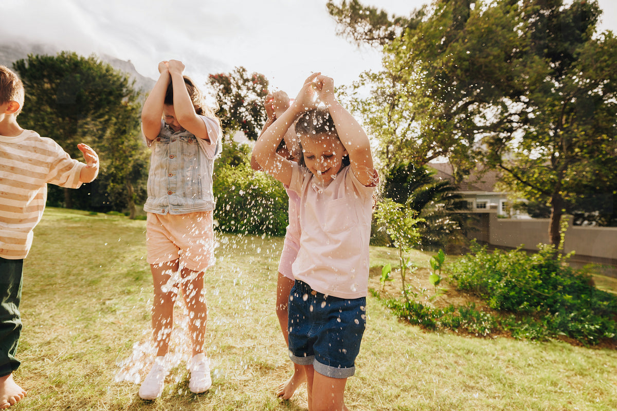 Children playing with water in a sunny backyard during summer – Jacob ...