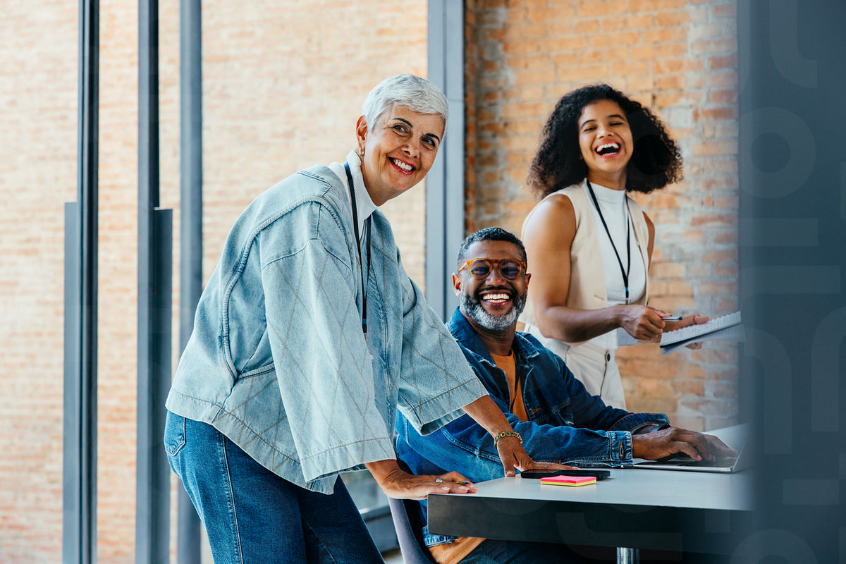 Joyful group of professionals working together in a modern office envi ...
