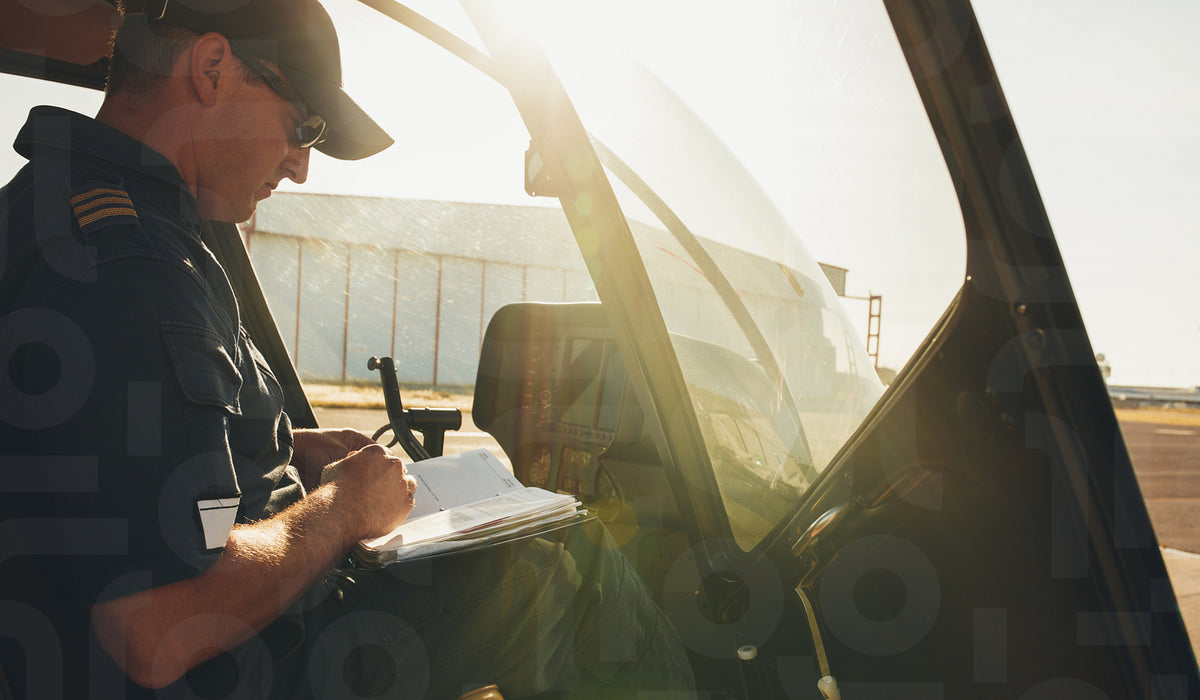 Pilot checking the flight manual before a take off – Jacob Lund ...