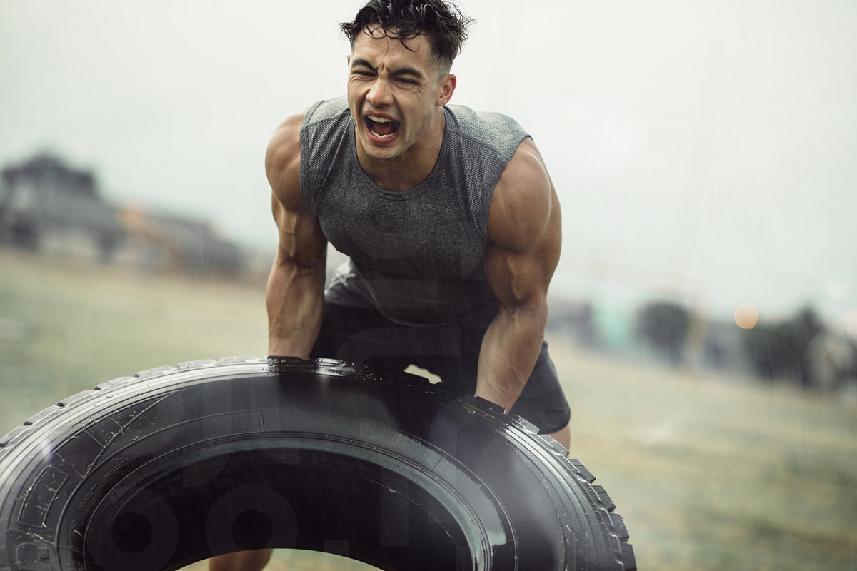 Strong sportsman doing a tire flip exercise – Jacob Lund Photography ...